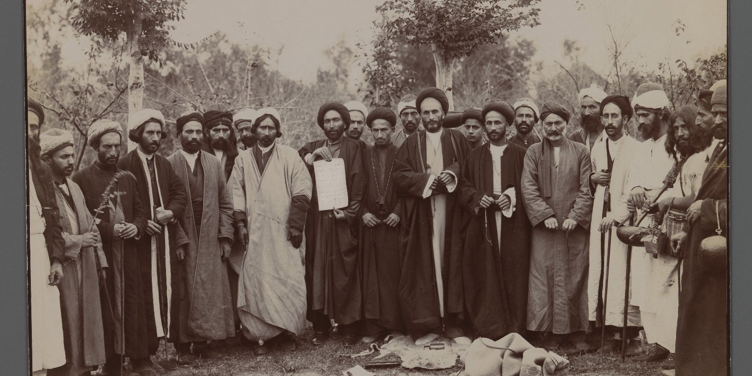 A Group of Religious Men in Religious Garb holding up a Piece of ...