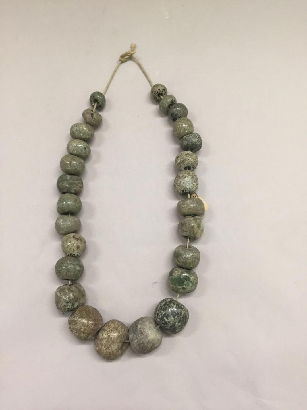 Circular Stone Beads (26) now Strung on Cotton Like a Necklace · Brooklyn Museum